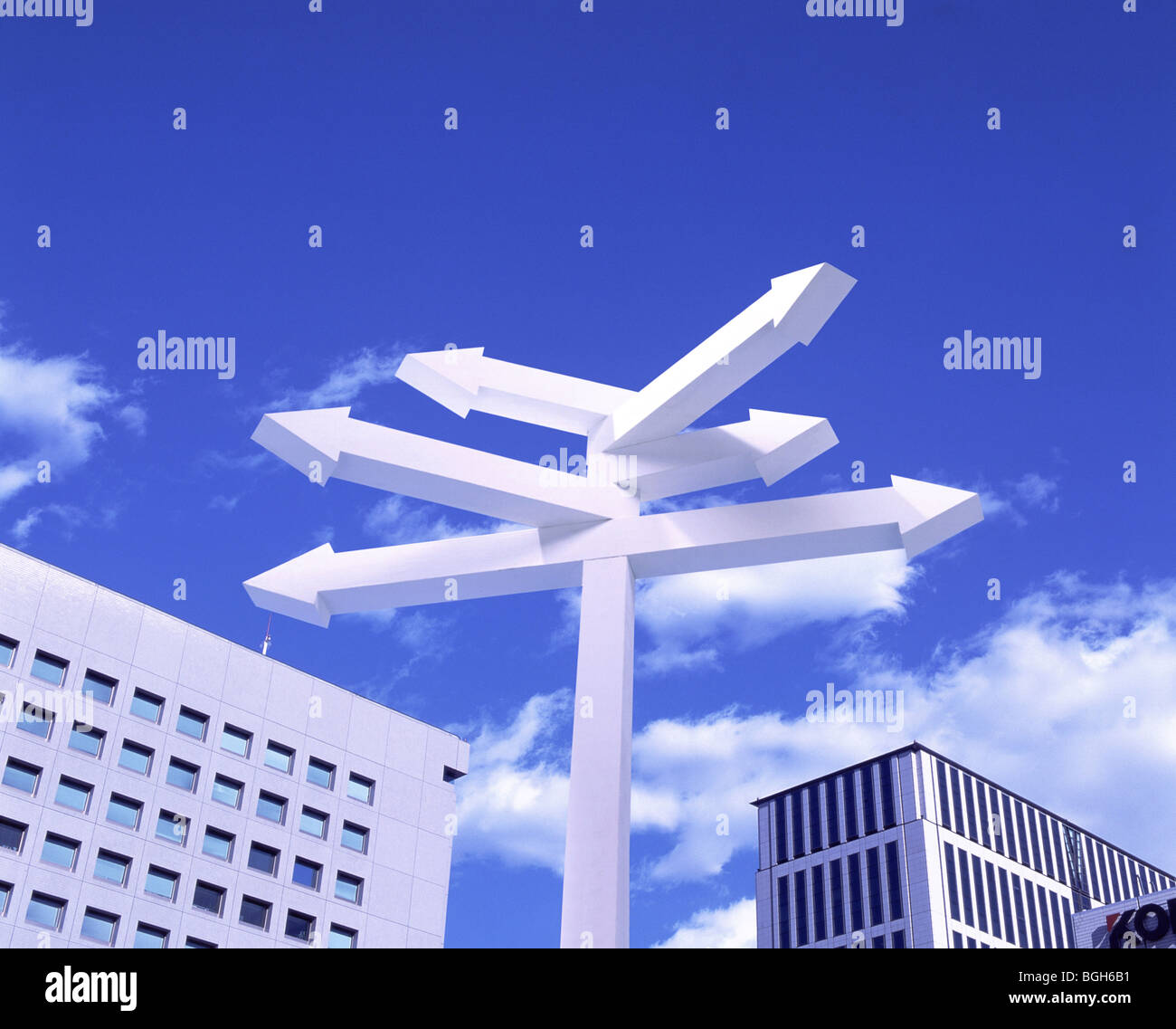 Sign in a city with arrows pointing in different directions Stock Photo ...