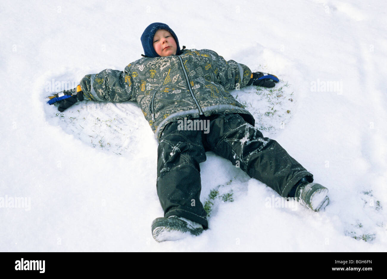 young boy making a snow angel Stock Photo - Alamy