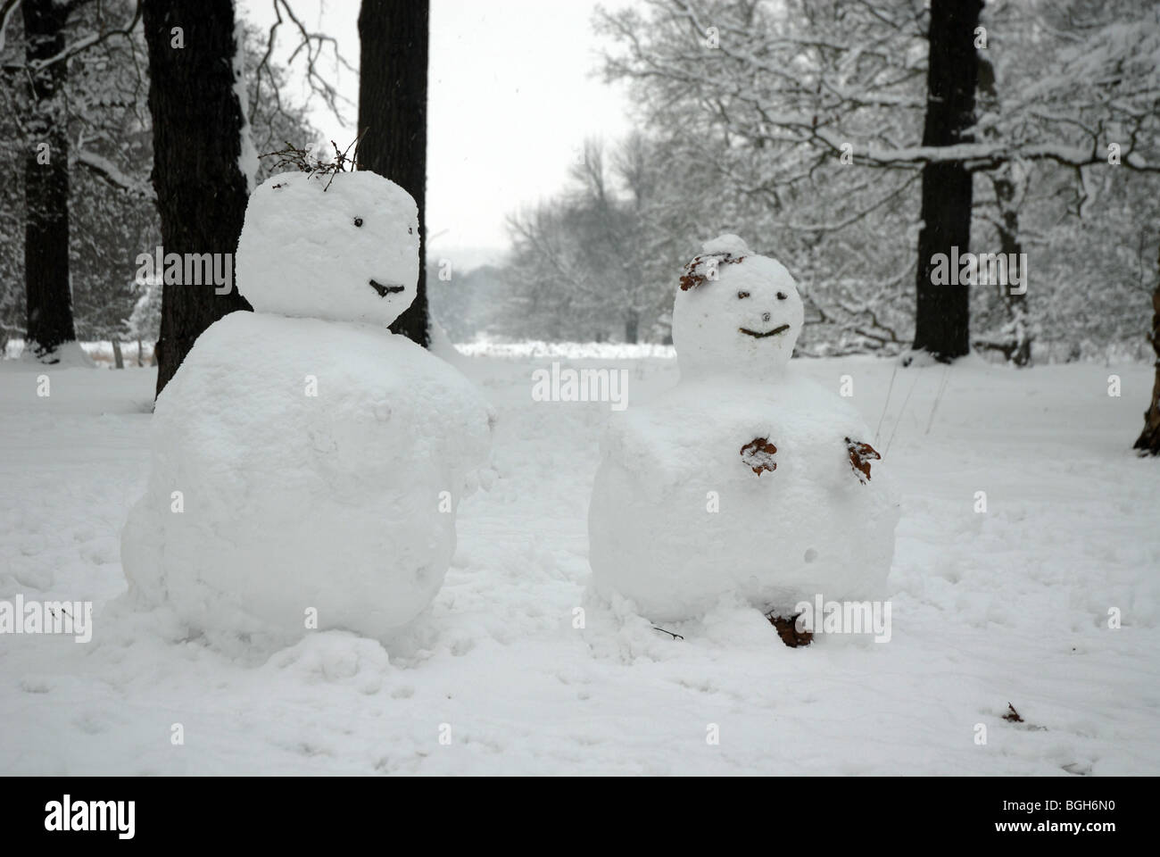 Two female snowmen in parkland setting Stock Photo - Alamy