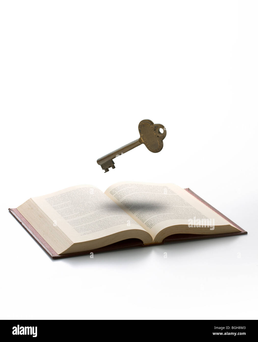 Key floating above an open book Stock Photo - Alamy