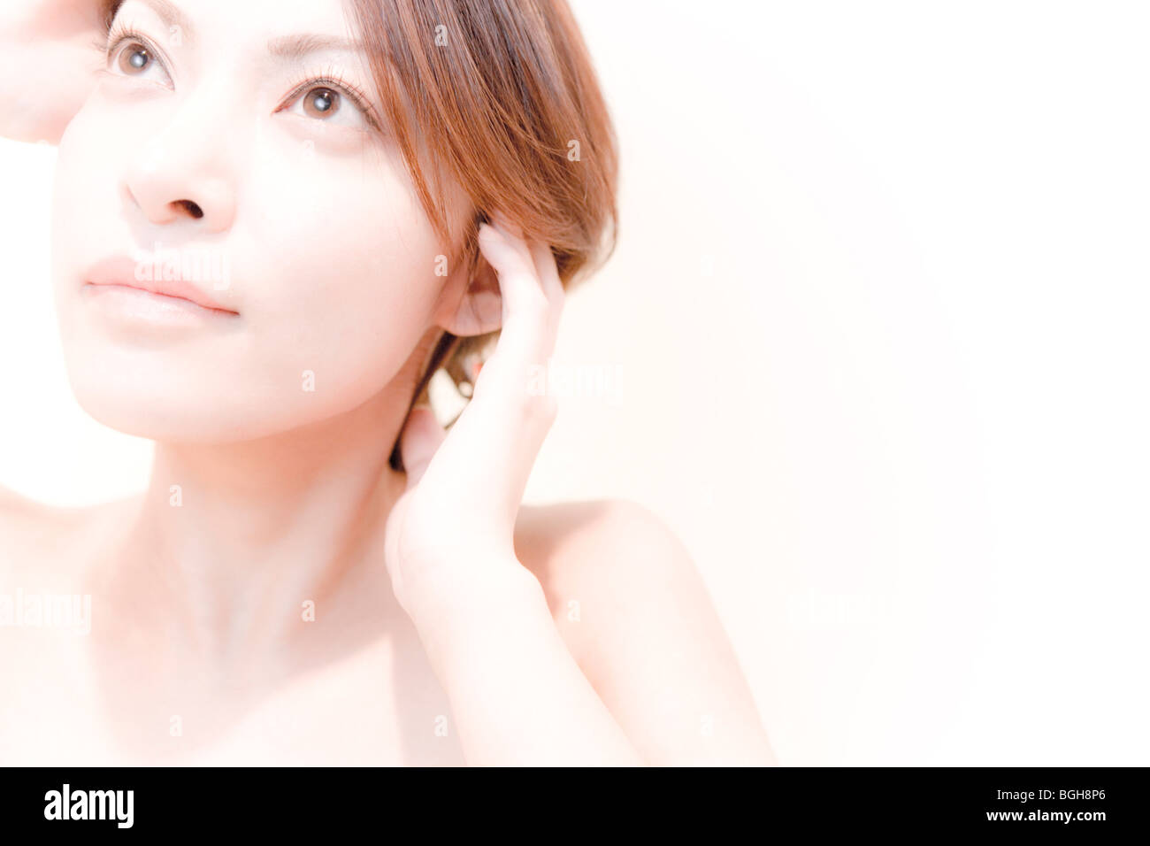 Young Woman Running Her Hands Through Her Hair Stock Photo - Alamy