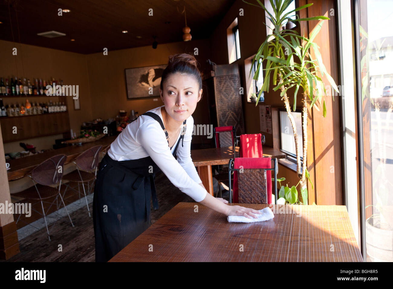 Young Woman Wiping Table Stock Photo - Alamy