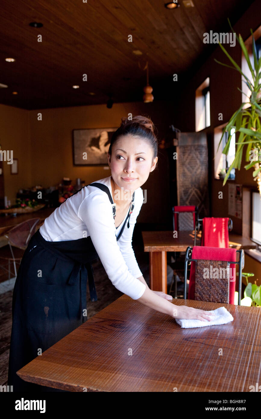 Young waitress wiping table hi-res stock photography and images - Alamy