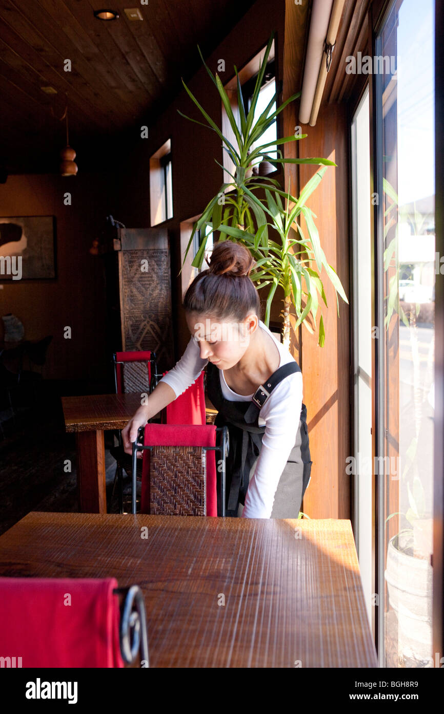 Young Woman Setting Chair Stock Photo - Alamy