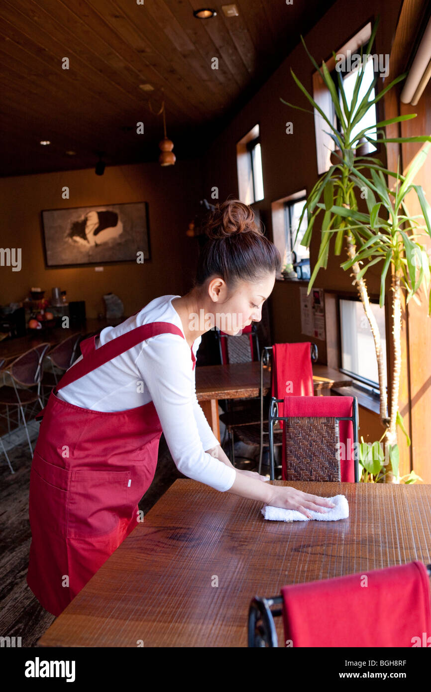 Young Woman Wiping Table Stock Photo - Alamy