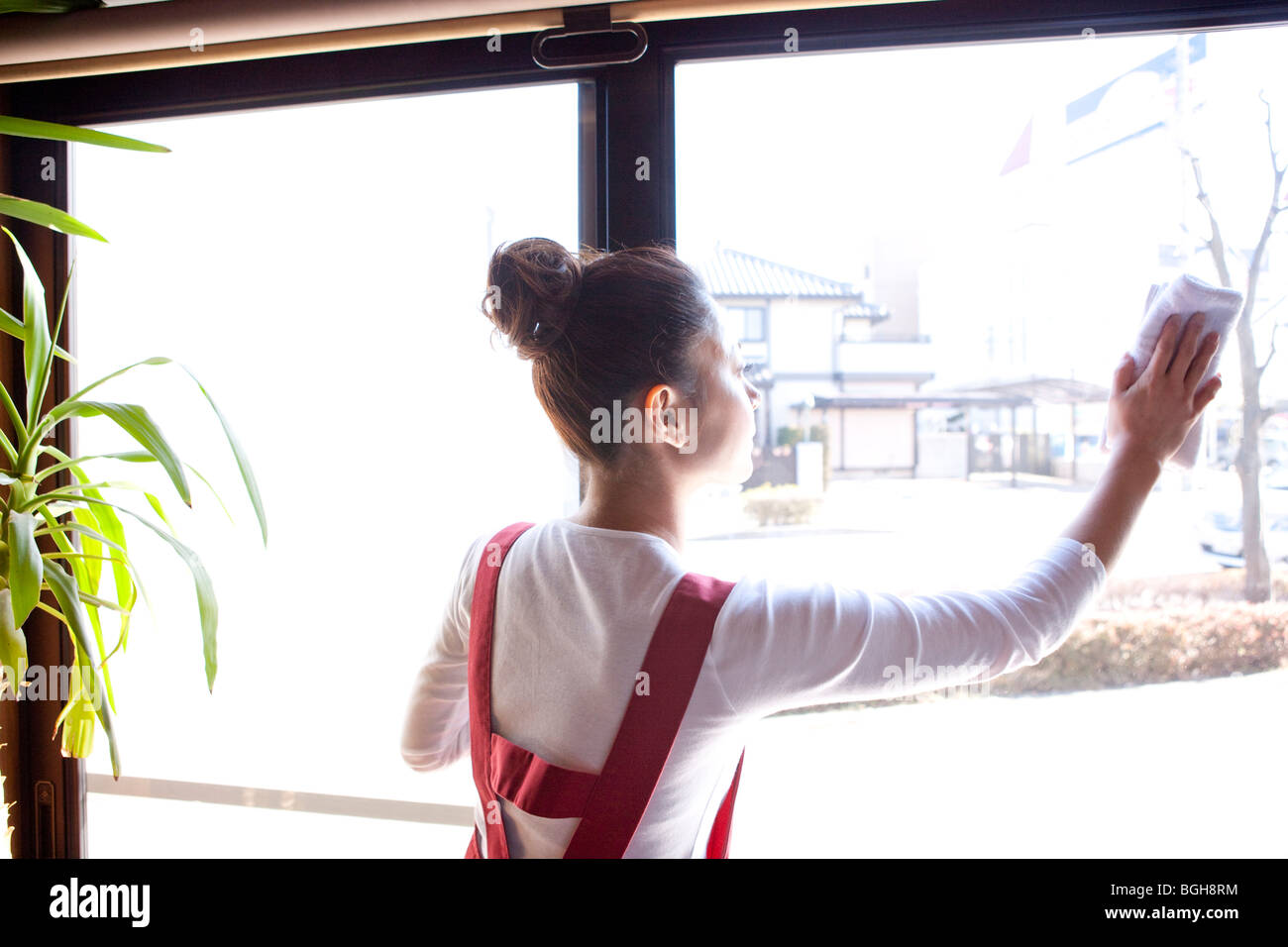 Young Woman Wiping Window Stock Photo - Alamy