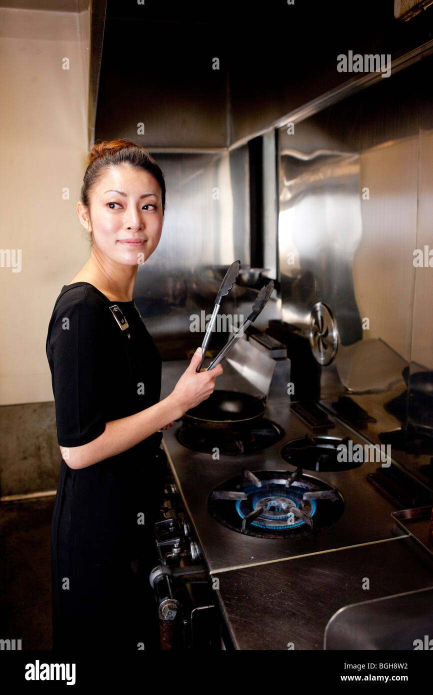 Young Woman Cooking at Kitchen in Restaurant Stock Photo - Alamy