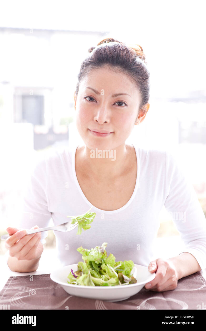 Woman sitting table eating food hi-res stock photography and images - Alamy