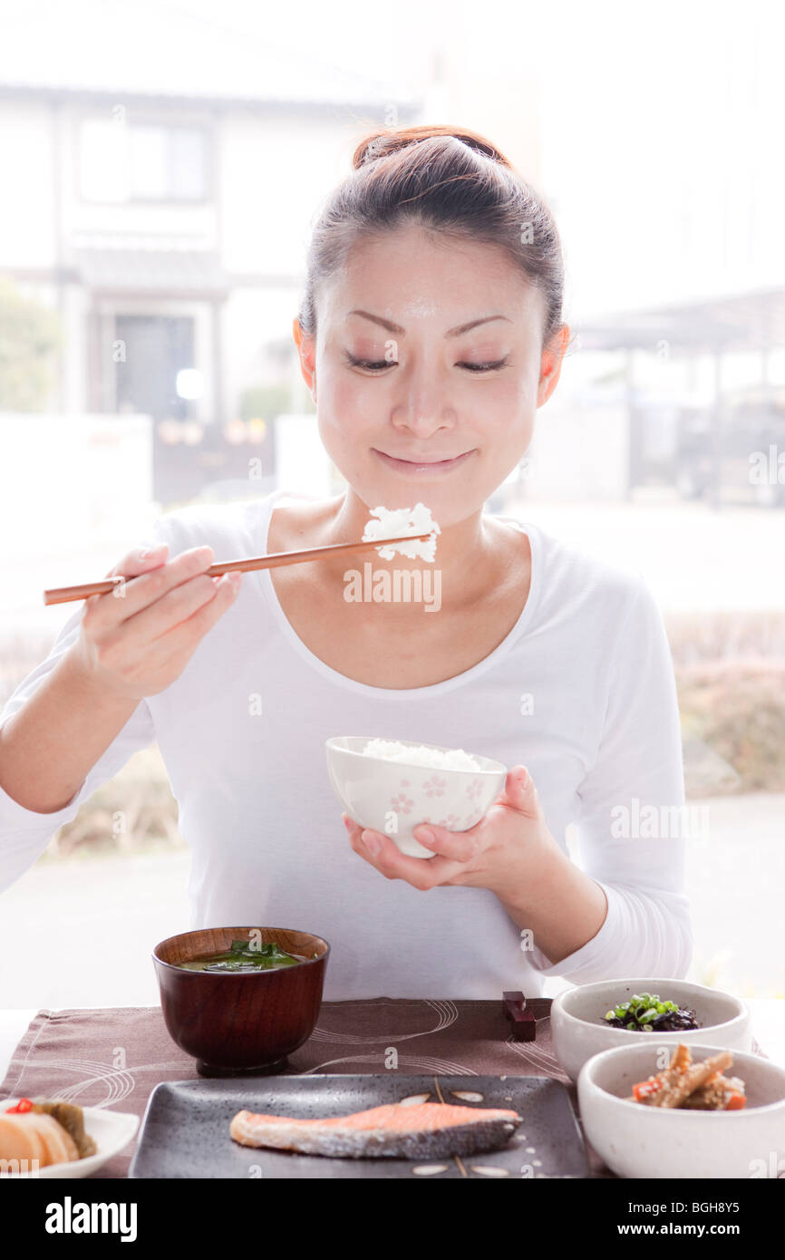 Young Woman Eating Japanese Cuisine Stock Photo - Alamy