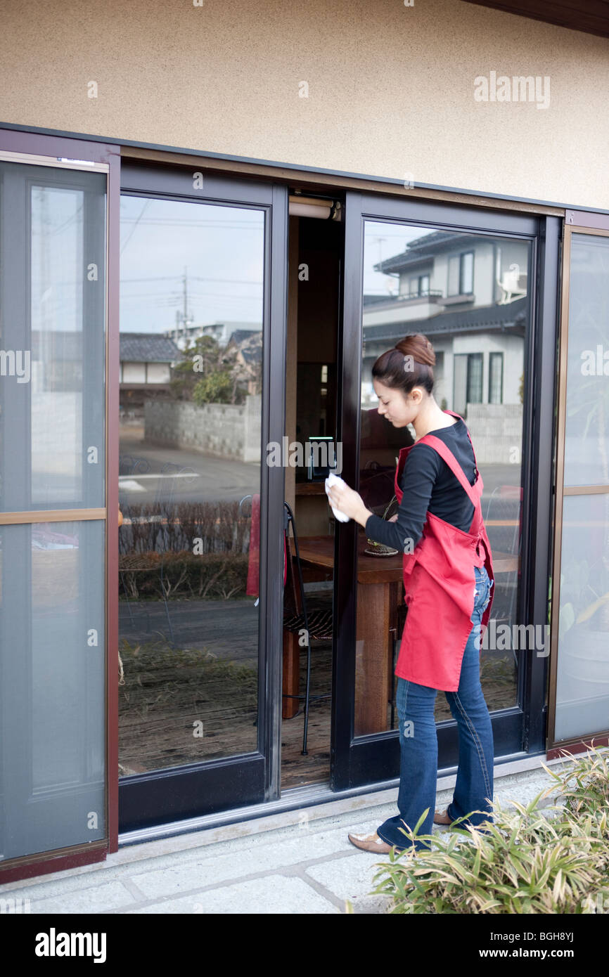 Young Woman Wiping Window Stock Photo - Alamy