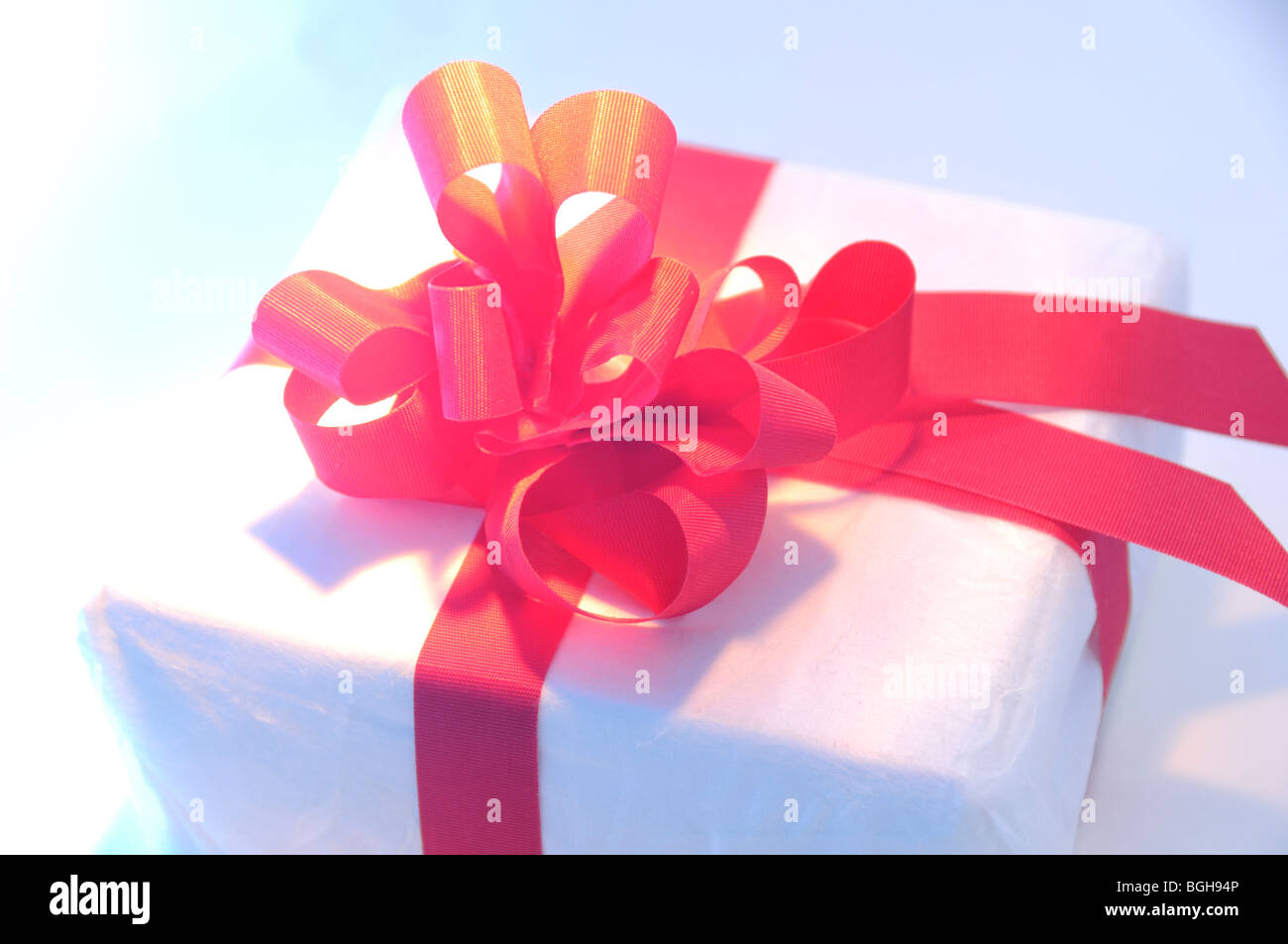 Gift with red ribbon Stock Photo - Alamy