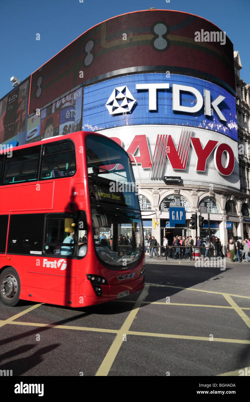 A red London bus passing through Piccadilly Circus, Central London, UK ...