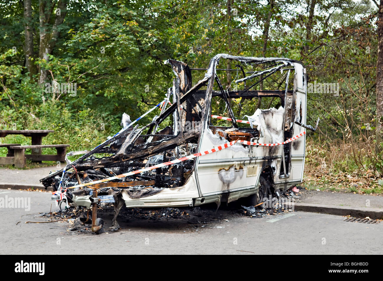 Fire damaged and burnt out caravan with police tape around it at ...