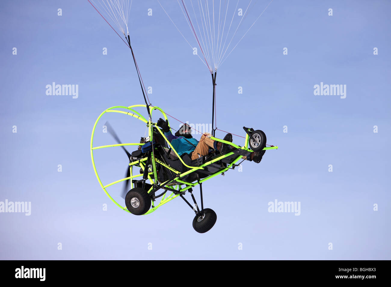 Pilot flying a powered parachute closeup showing strings and tricycle ...