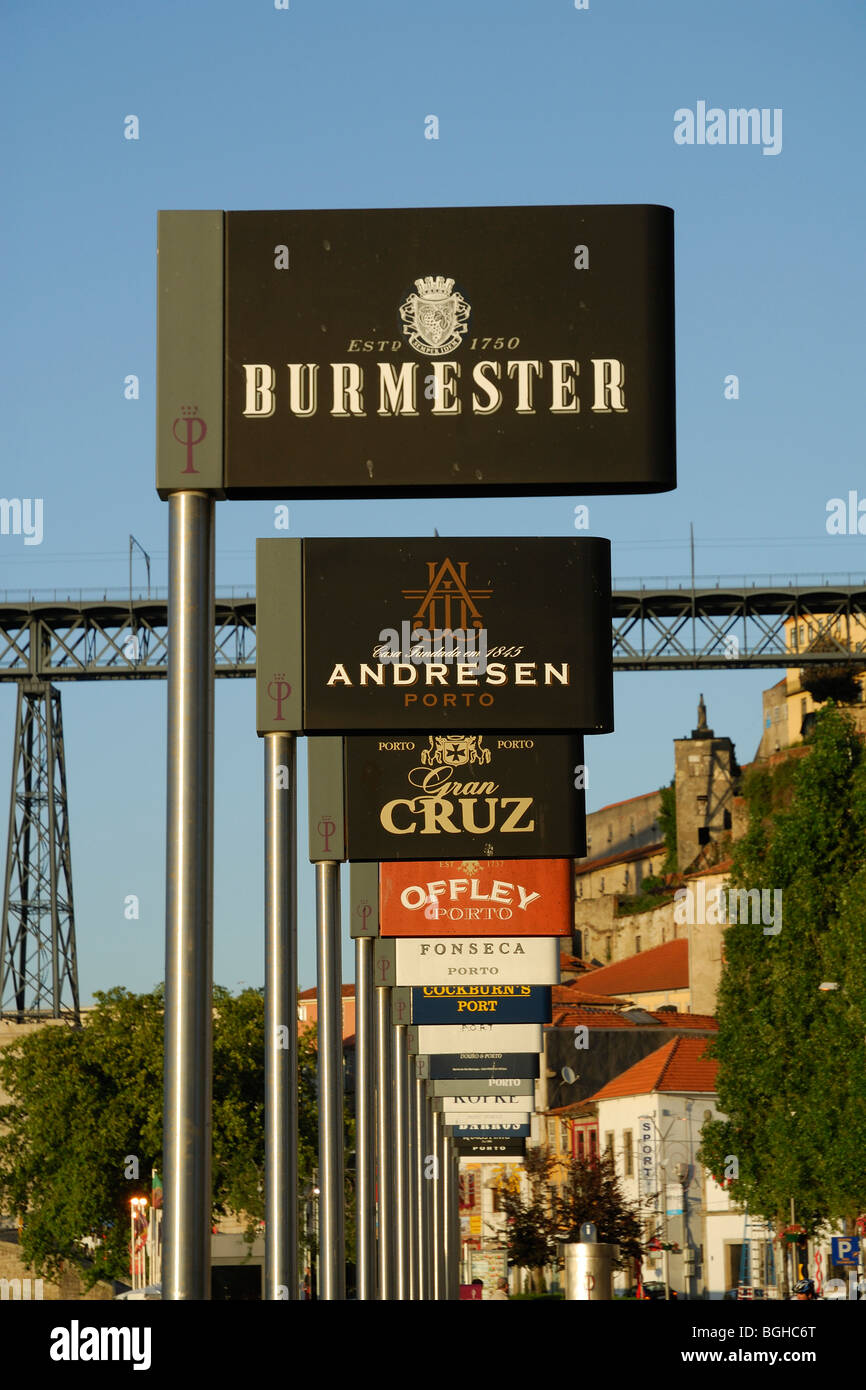 Porto. Portugal. Signs of famous Port Wine producers line the promenade ...
