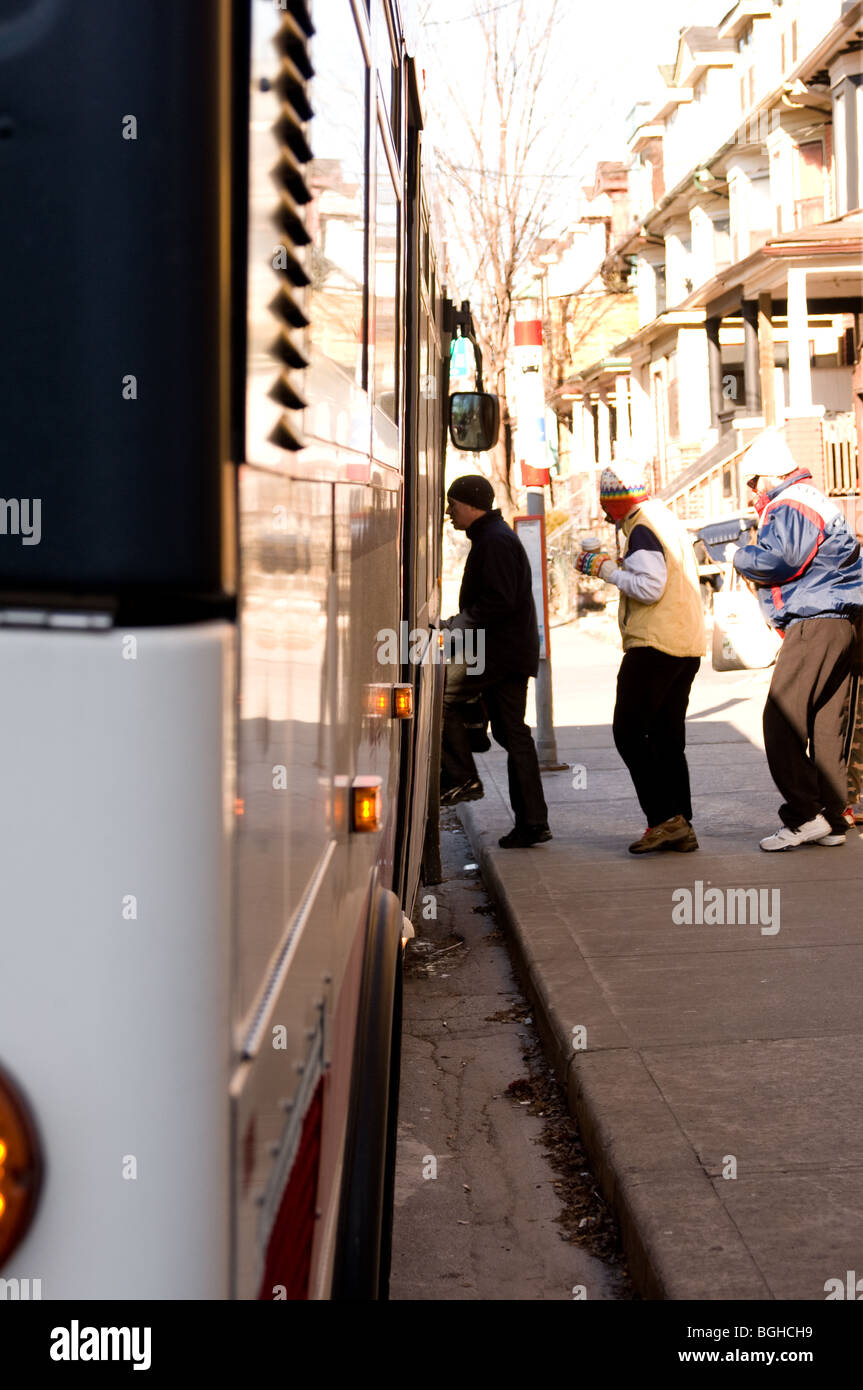 Commuters getting on a bus Stock Photo - Alamy