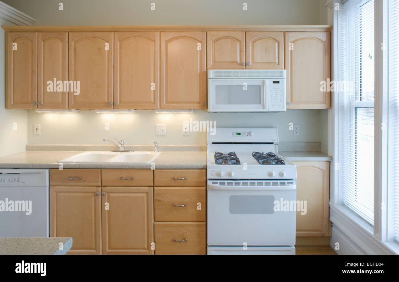 Empty kitchen with light colored cabinets Stock Photo - Alamy