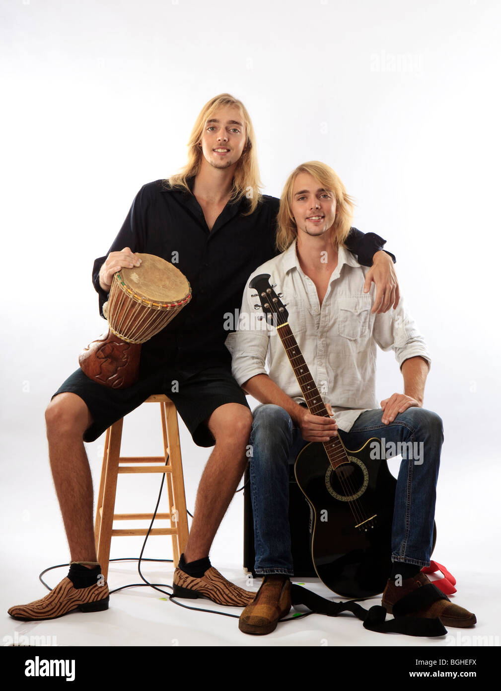 twin brothers in their twenties with guitar and drum Stock Photo - Alamy