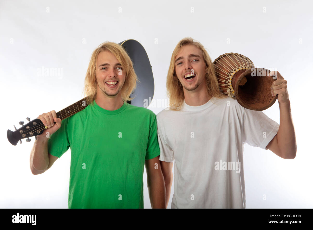 twin brothers in their twenties with guitar and drum Stock Photo - Alamy