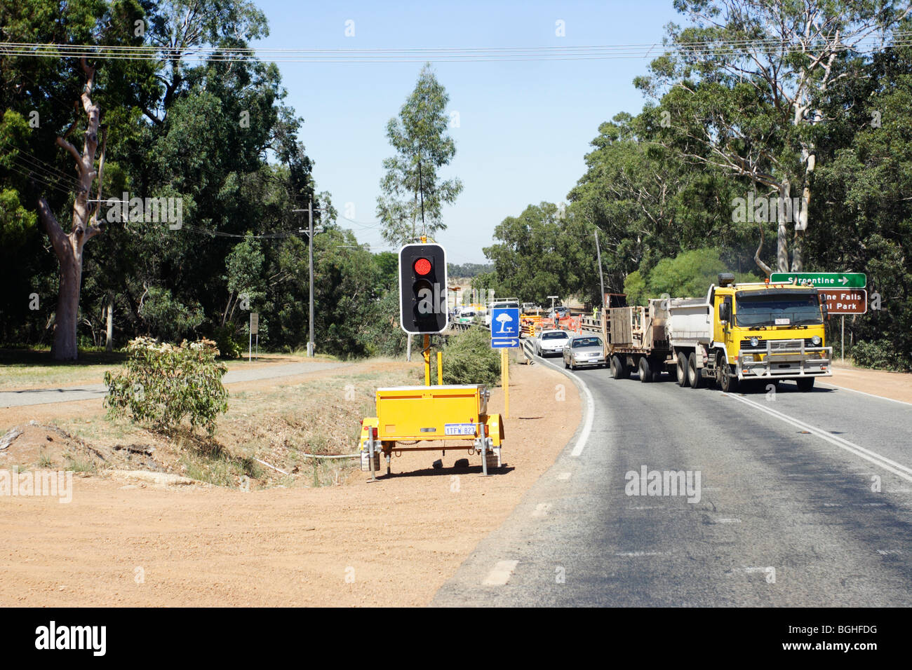 Using portable traffic light to control traffic at a road under ...