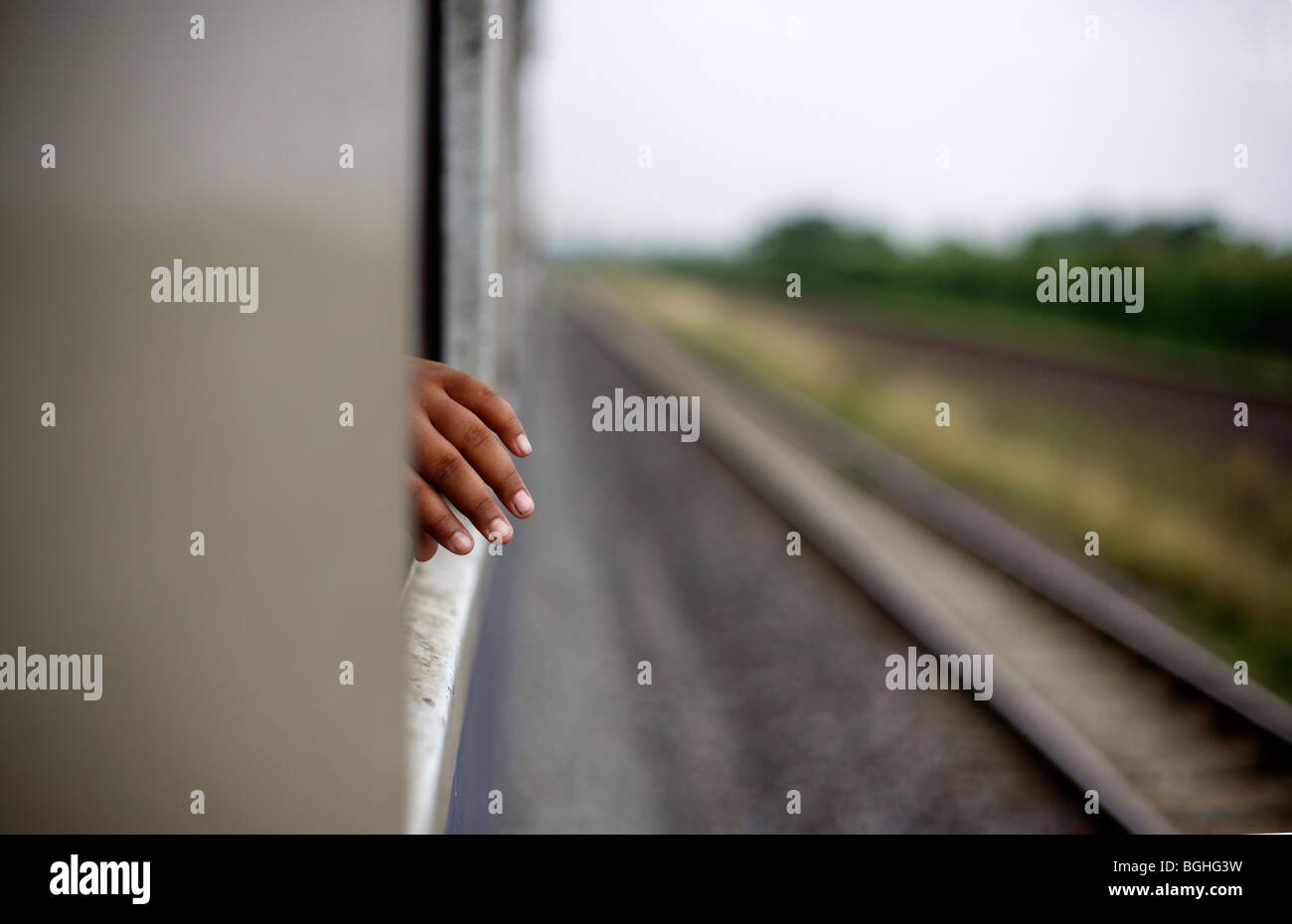 A hand in the window of a train in motion in Thailand Stock Photo - Alamy