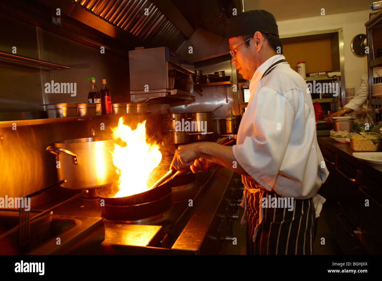 Asian chef cooking in Restaurant kitchen Stock Photo - Alamy