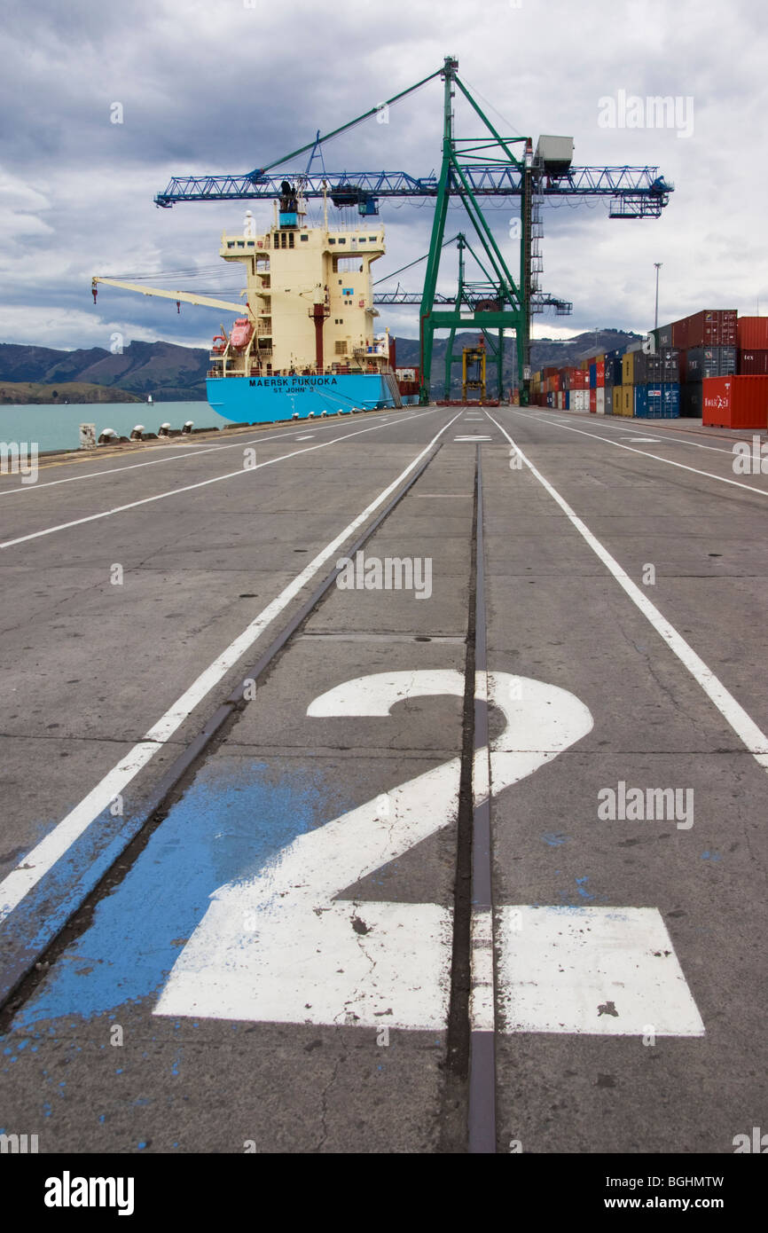 Small containership moored alongside the quay at container terminal ...
