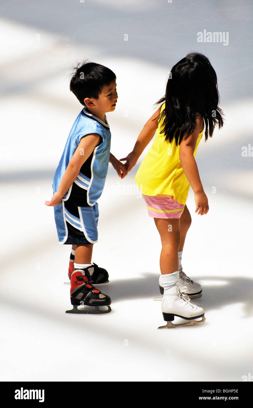 Boy and girl children ice skating hi-res stock photography and images ...