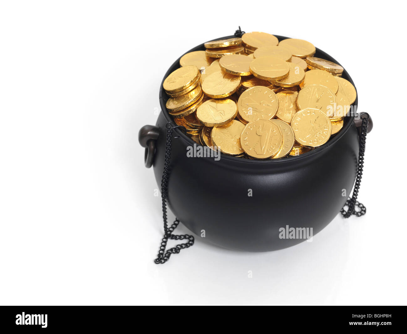 Cauldron full of money, fake golden loney coins. Isolated on white ...