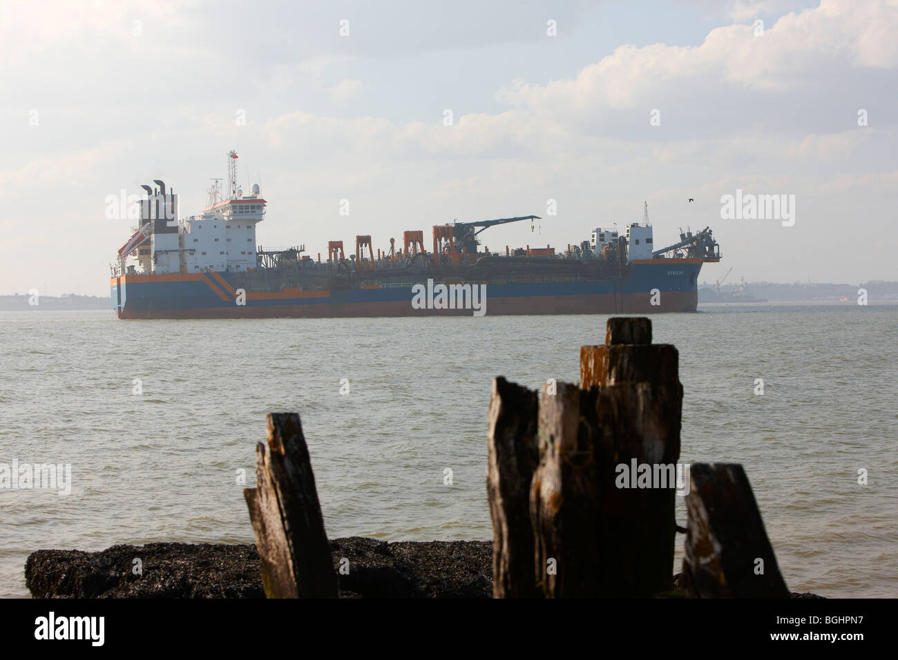 Cargo Container Ship Stumps of old piers Stock Photo - Alamy