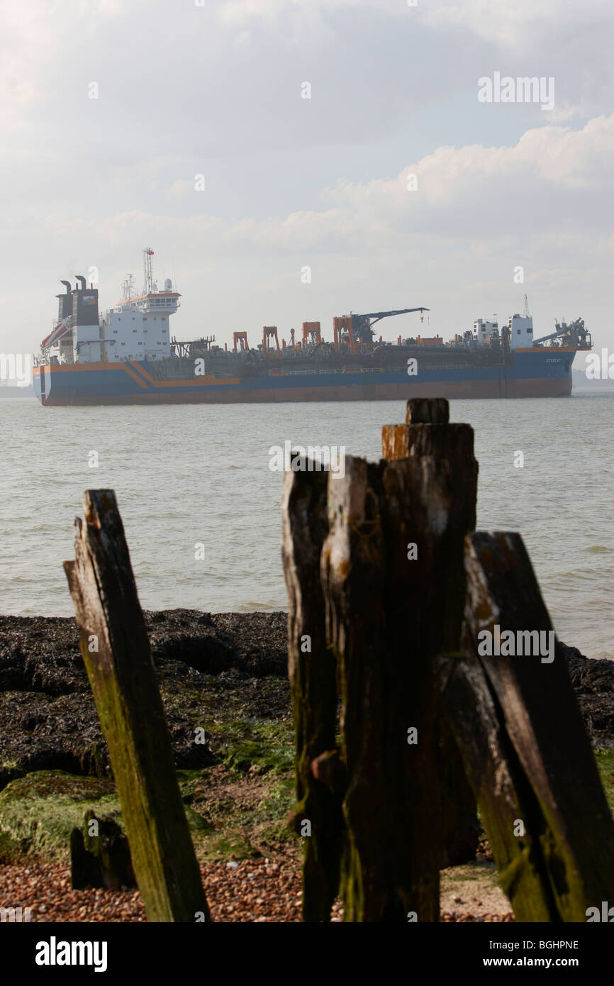 Cargo Container Ship Stumps of old piers Stock Photo - Alamy
