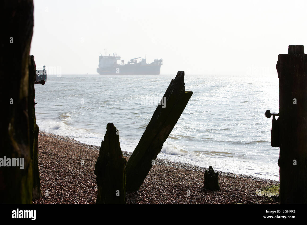 Cargo Container Ship Stumps of old piers Stock Photo - Alamy