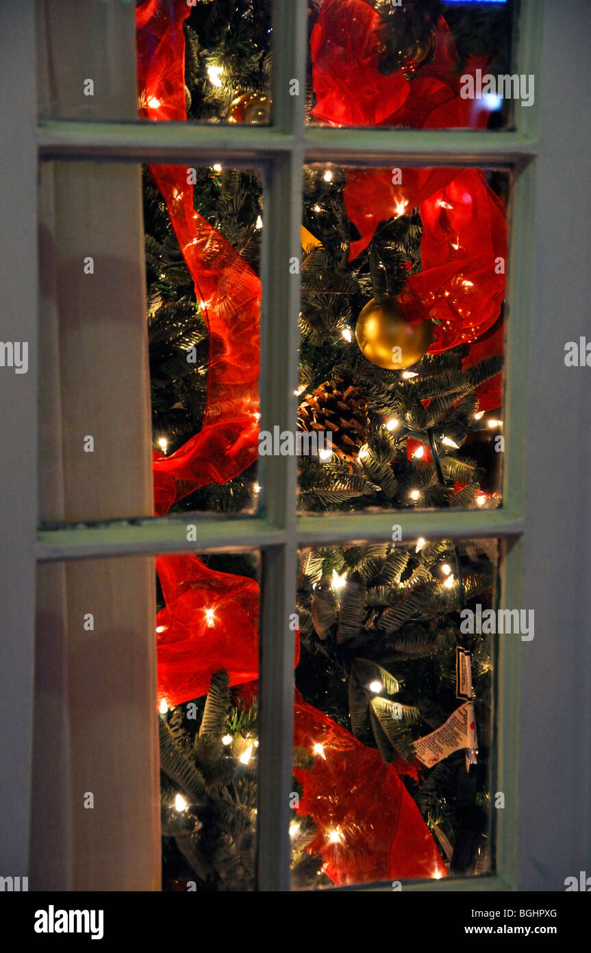 Christmas tree behind window Stock Photo - Alamy