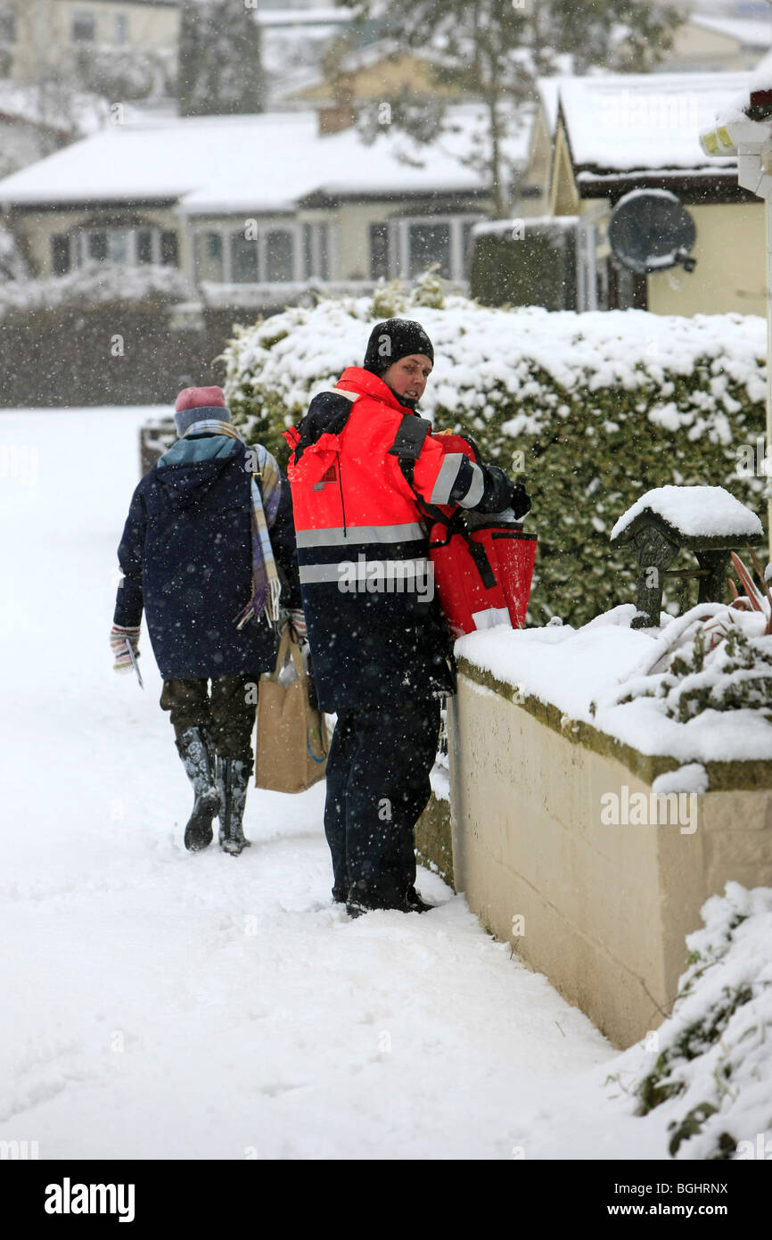 A Royal Mail Post woman battling through the winter snow to make her ...