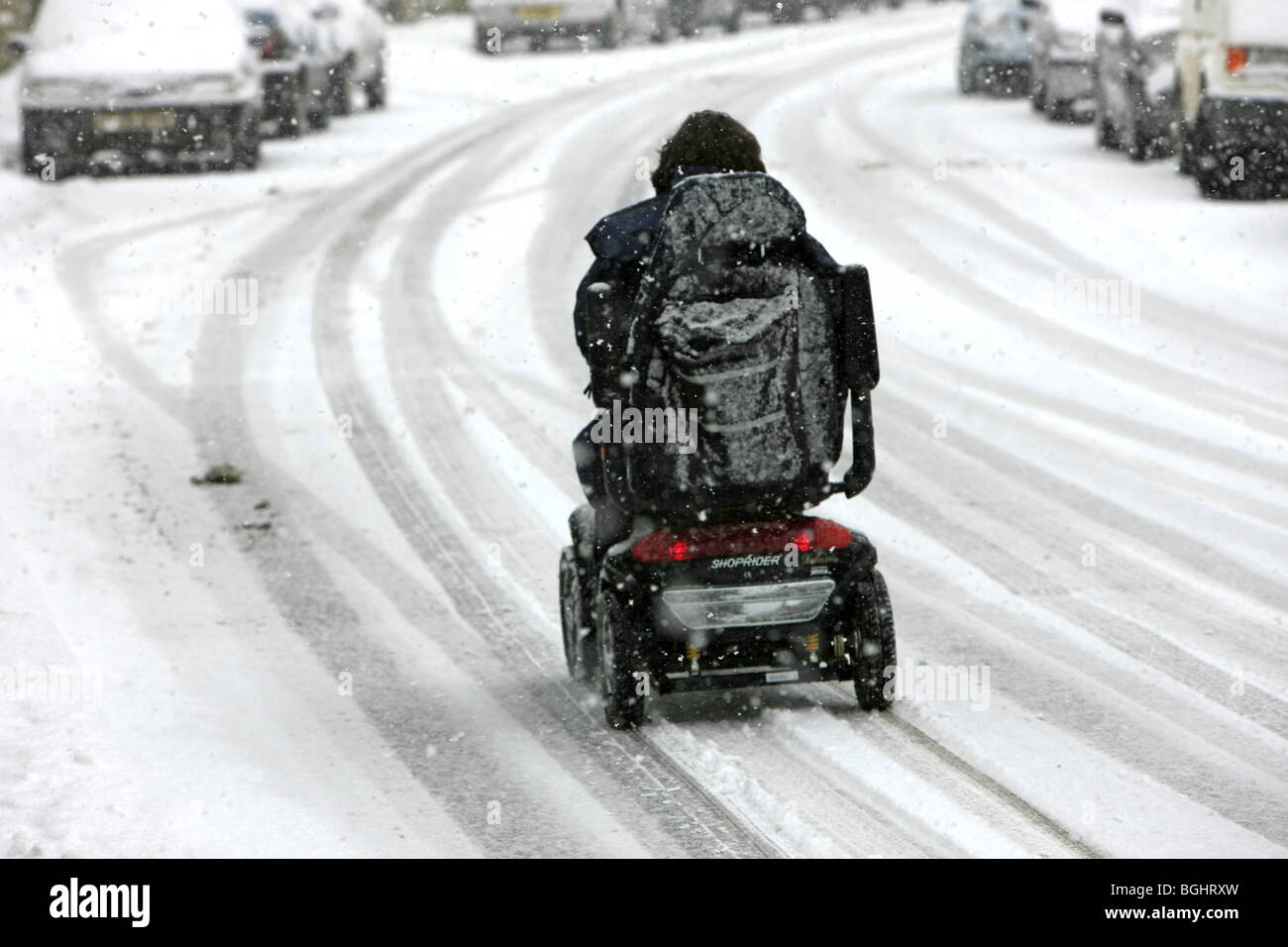 A driver of a mobility buggy braves the snow and ice to venture to the ...