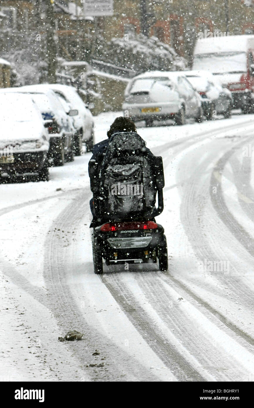 A driver of a mobility buggy braves the snow and ice to venture to the ...