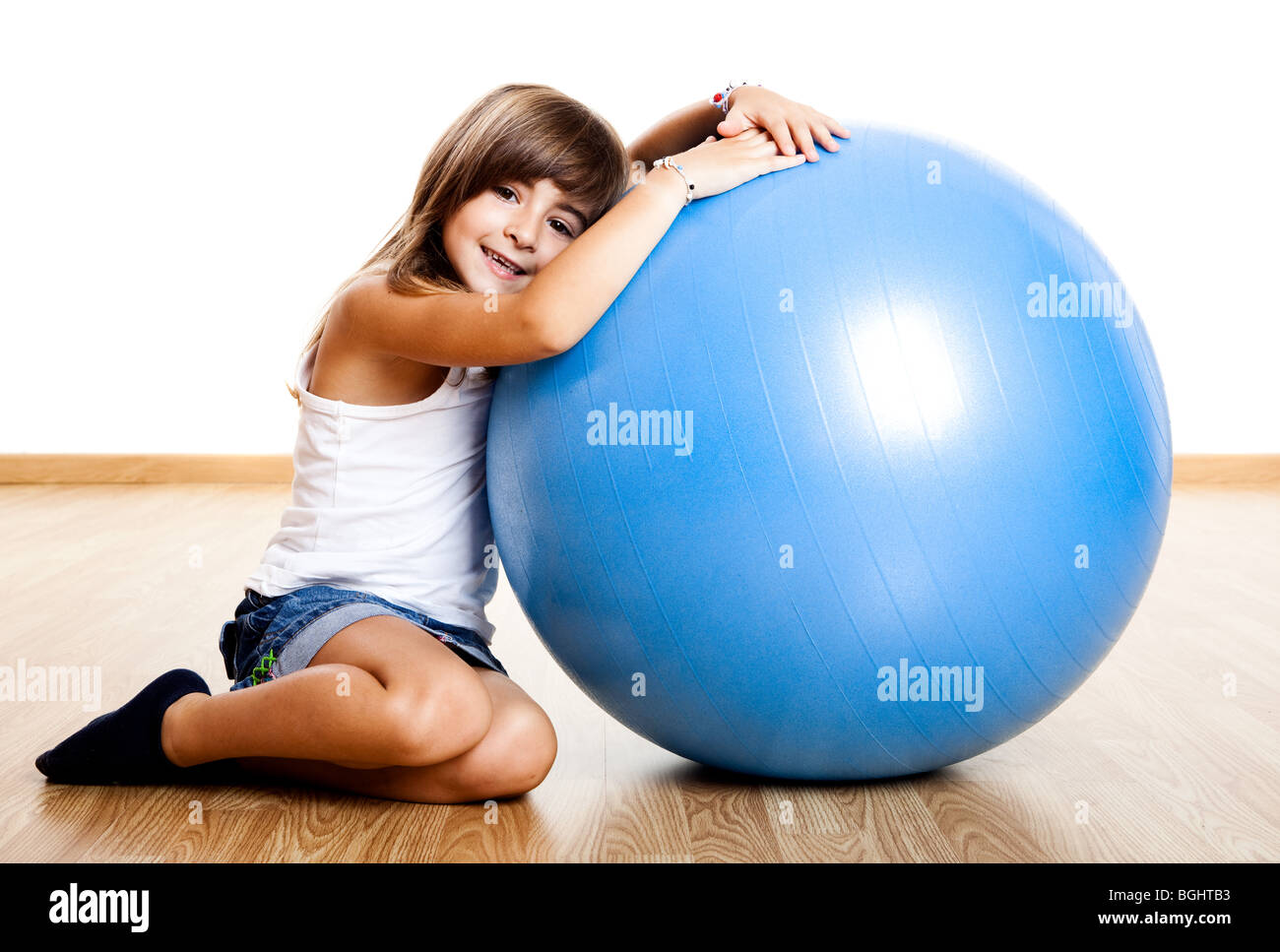 Happy little child playing with a big blue ball Stock Photo - Alamy