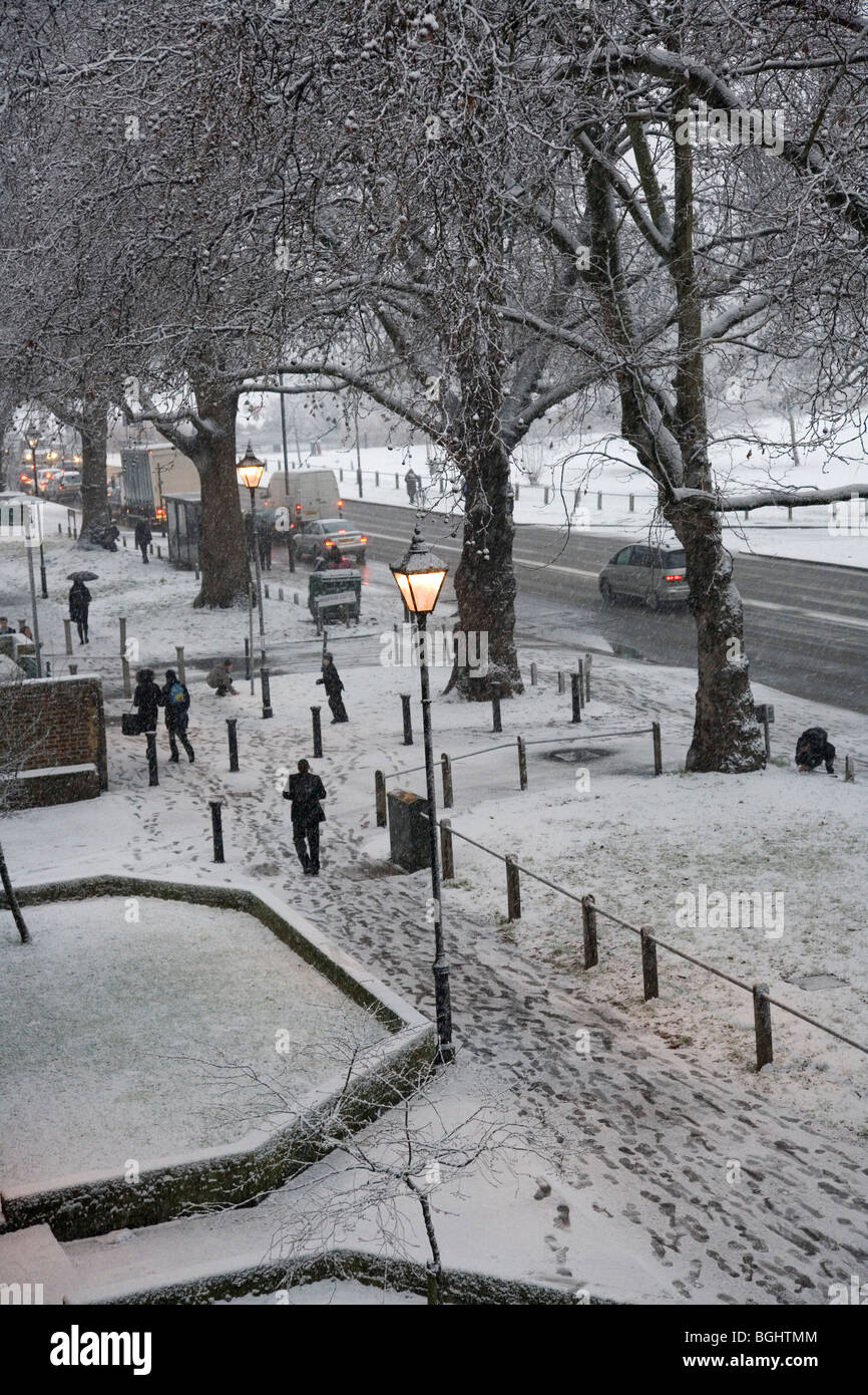 Snow falling on Clapham Common Southside Rd - some traffic Stock Photo ...