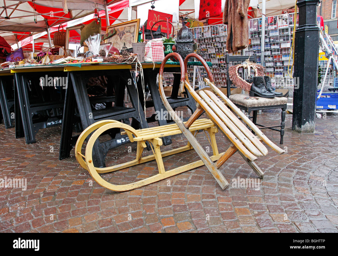 Two old fashioned sledges on sale at a market stall Stock Photo - Alamy