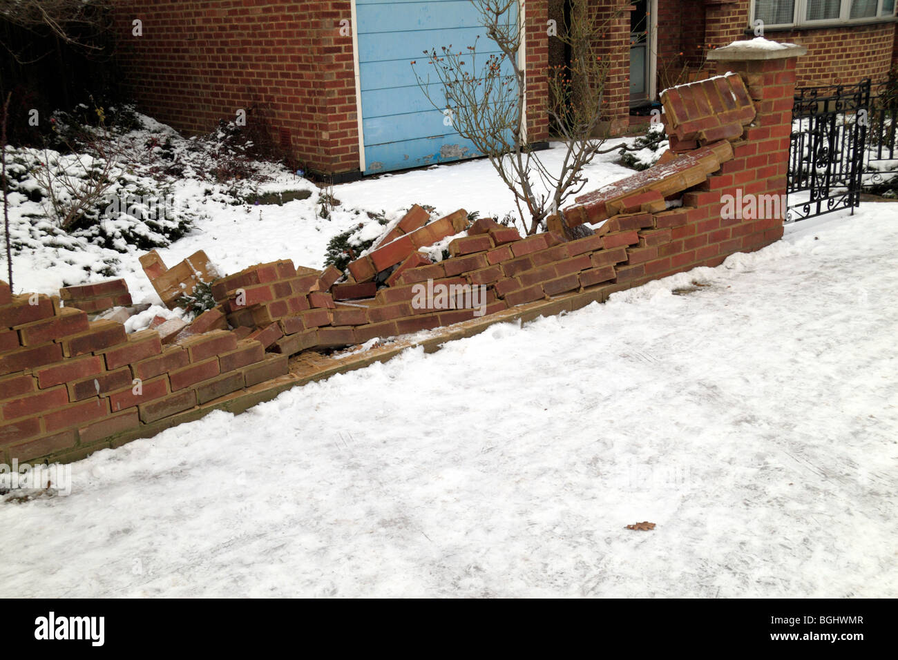 Skid marks and a smashed wall mark the spot a car skidded on winter ...