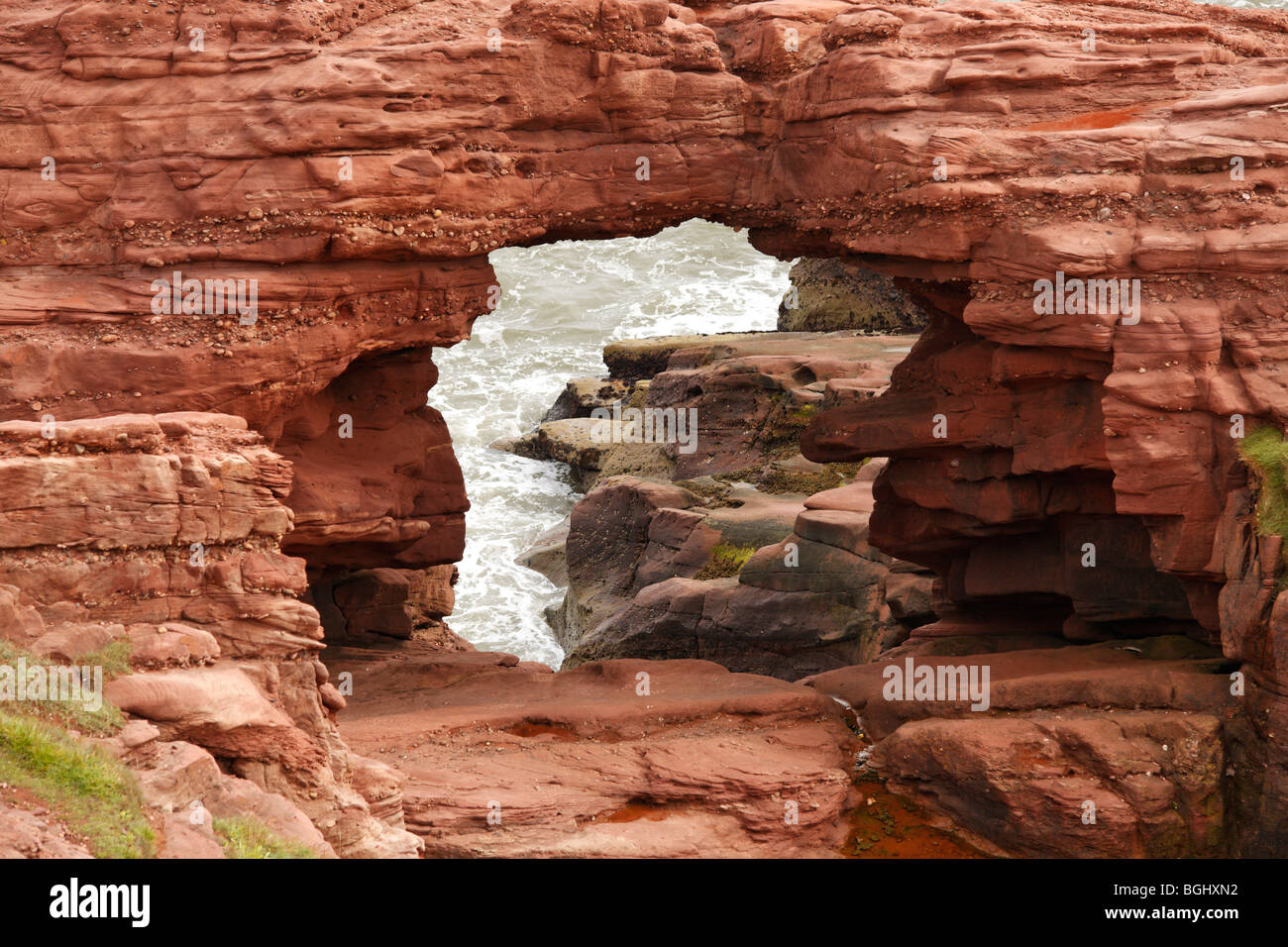 Red sandstone arch on the Seaton Trail coast, Angus, Scotland Stock ...