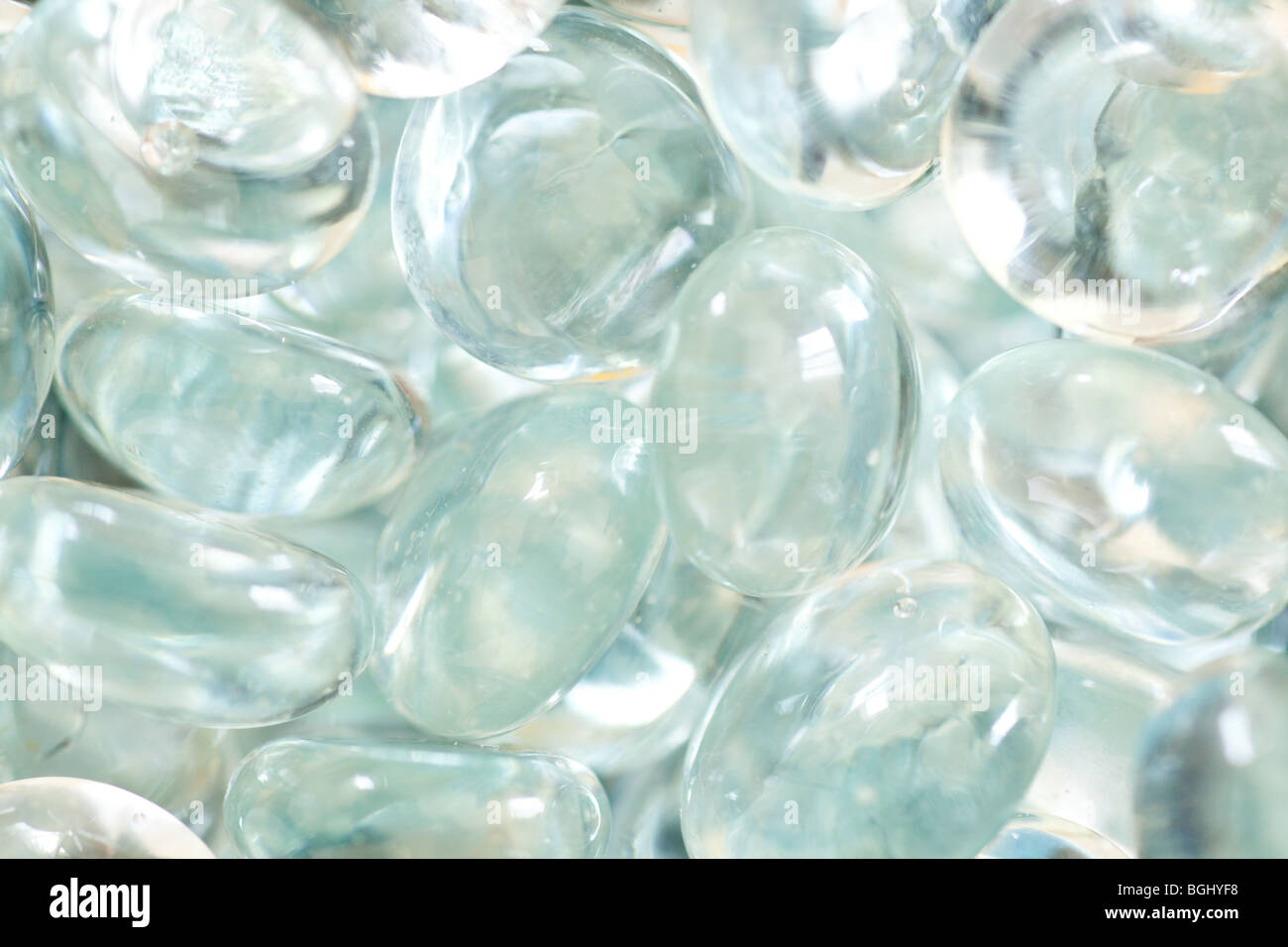 clear blue glass pebbles grouped together in background pattern Stock ...