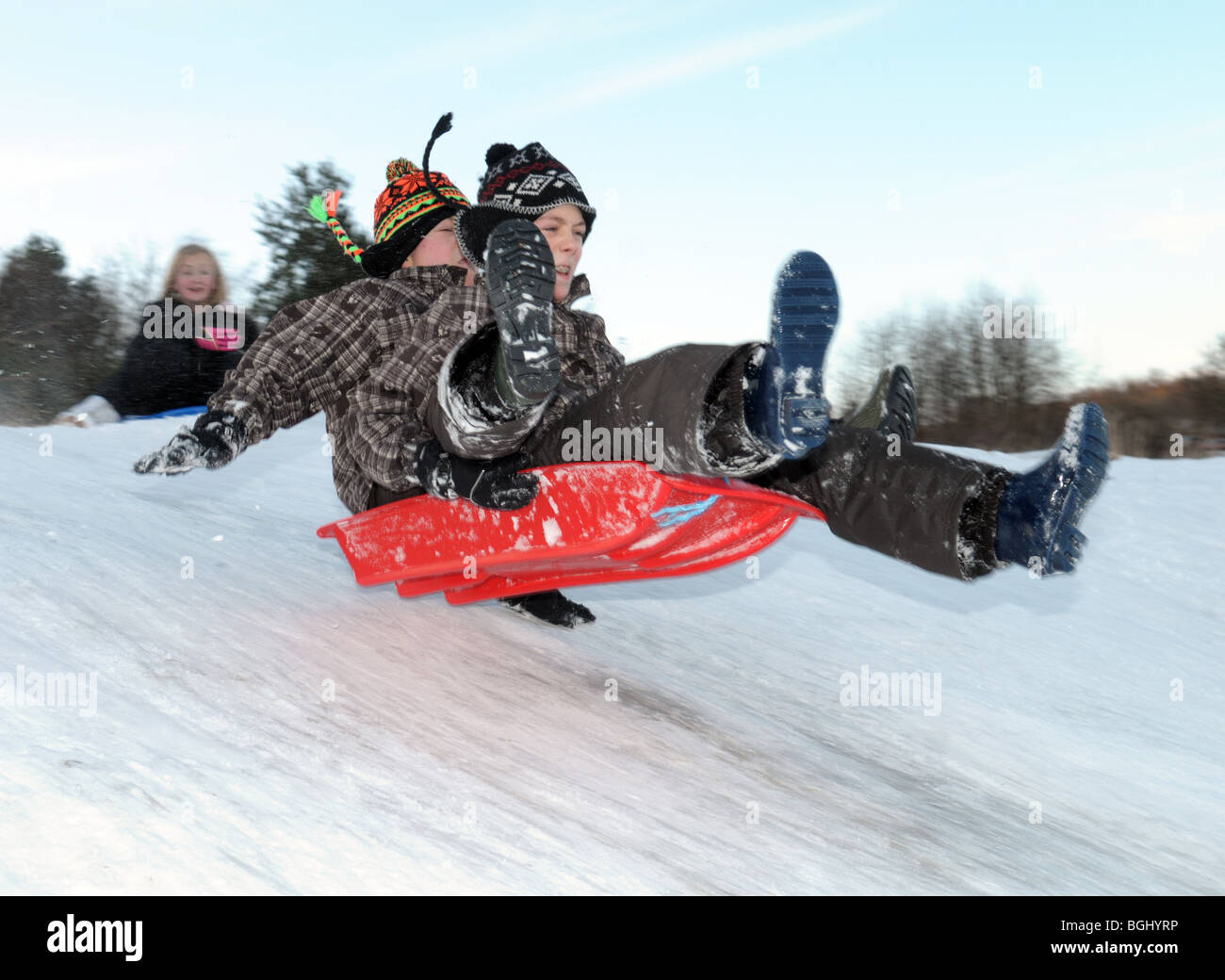 Young boys and girls sledging in Scotland Stock Photo - Alamy