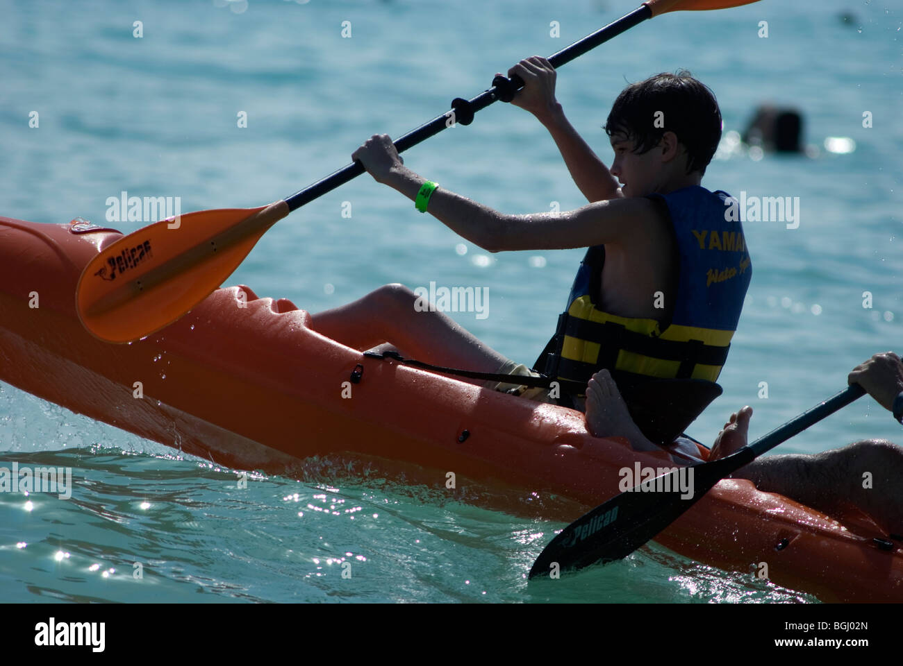 Boy riding a kayak at a resort in Riviera Maya, Mexico Stock Photo - Alamy