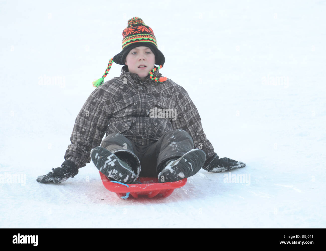 Young boys and girls sledging in Scotland Stock Photo - Alamy