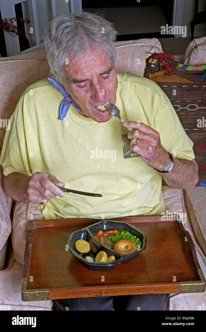Old age pensioner eating a Birds Eye traditional beef ready meal Stock ...