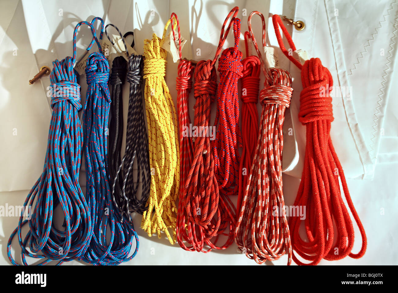 Coiled ropes, halyards, trimming and sheet lines lay on surface of ...