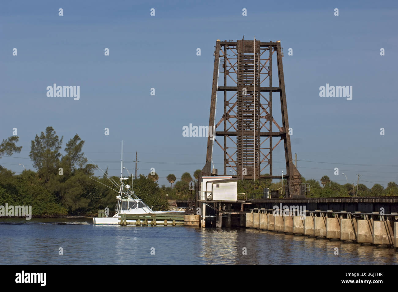 elevated railroad drawbridge and pwerboat in channel Stock Photo - Alamy