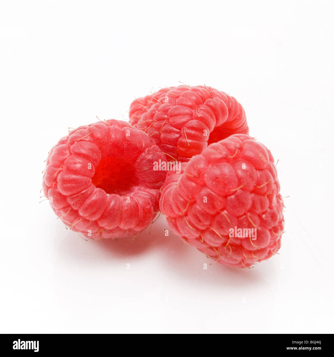 Red vibrant Raspberries isolated against white background Stock Photo ...