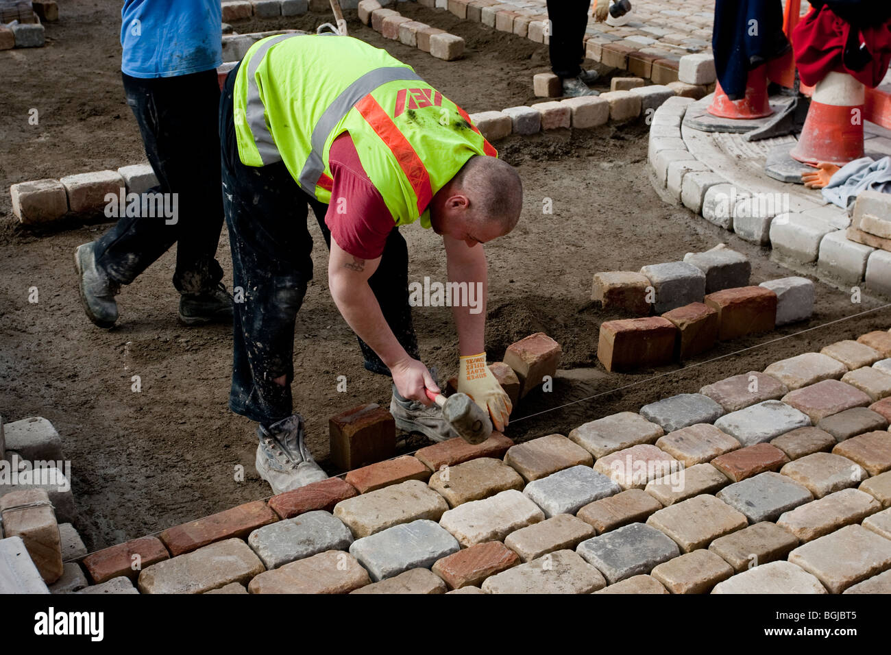 Modern cobblestone being laid Stock Photo - Alamy
